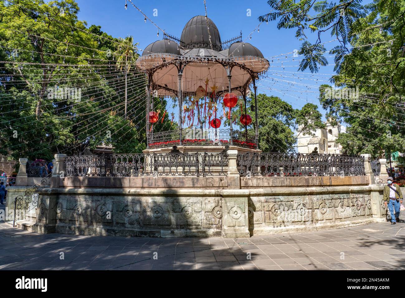 A central gazebo or bandstand decorated with Christmas lights in the ...