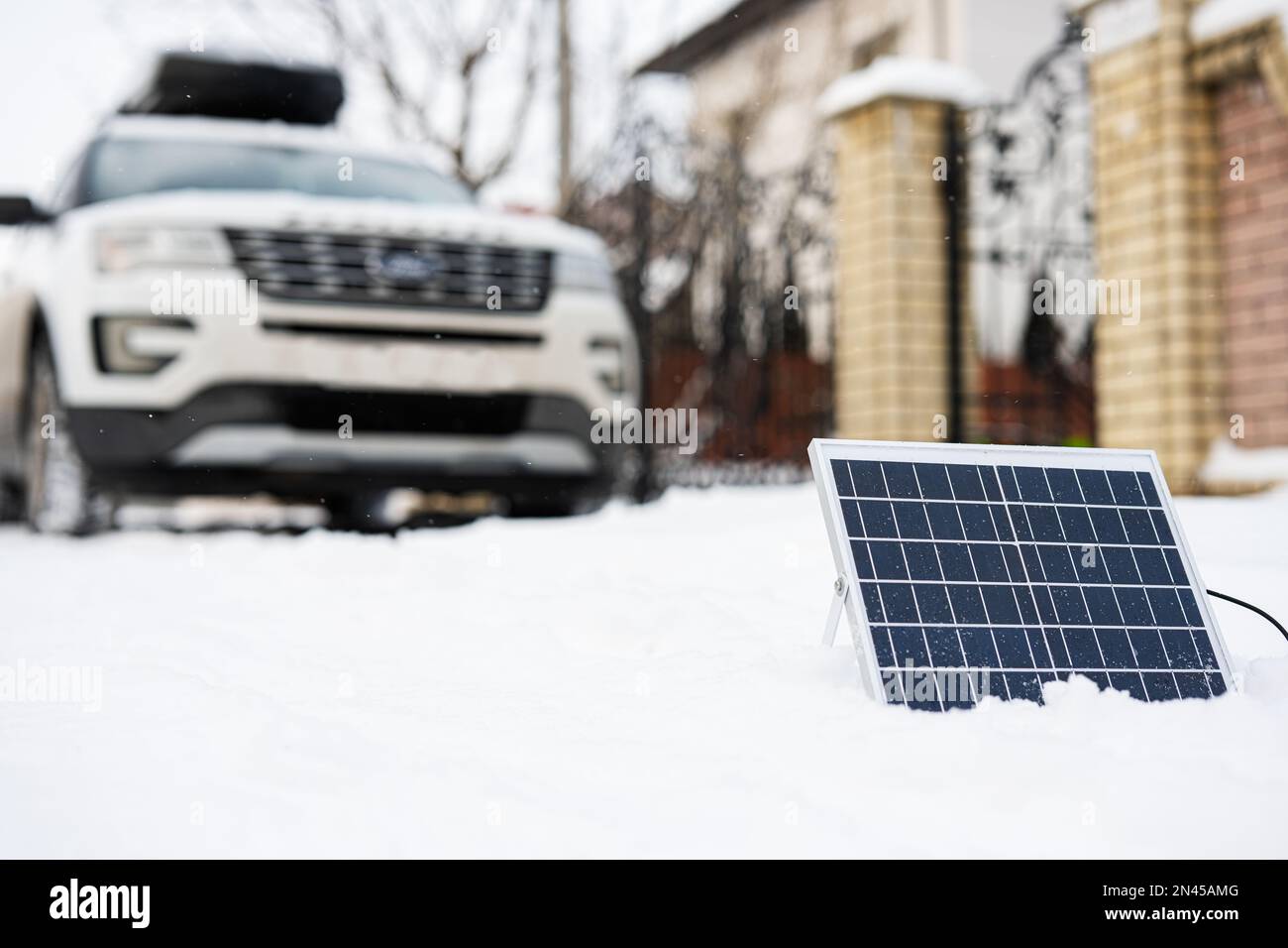 Portable solar panel against SUV car at winter Stock Photo - Alamy