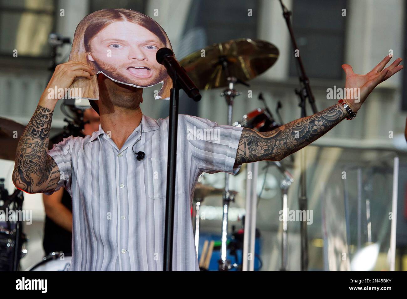 Adam Levine of Maroon 5 holds up a fans poster of bandmate James ...