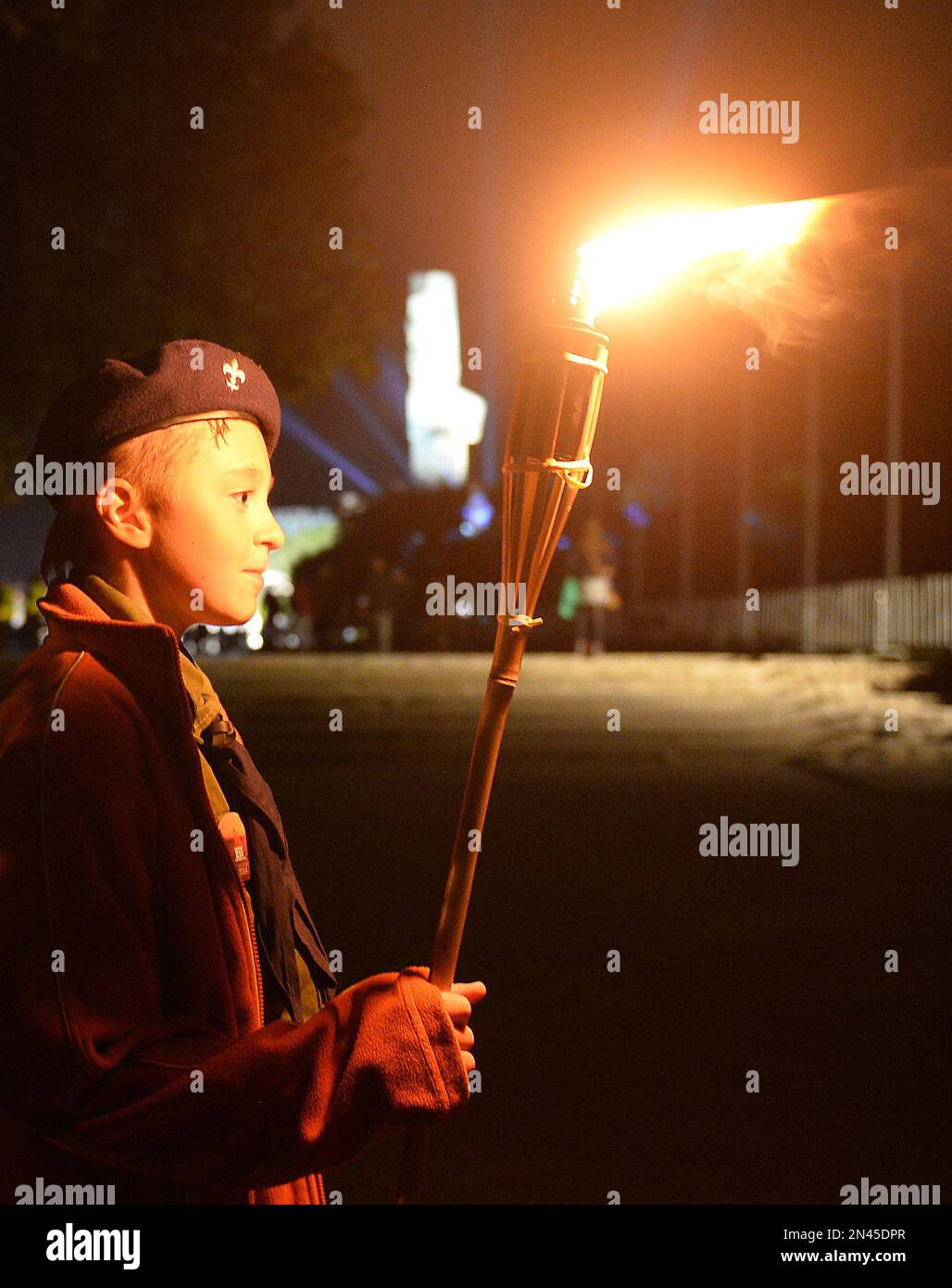 A scout stands with a torch in front of the Westerplatte monument ...