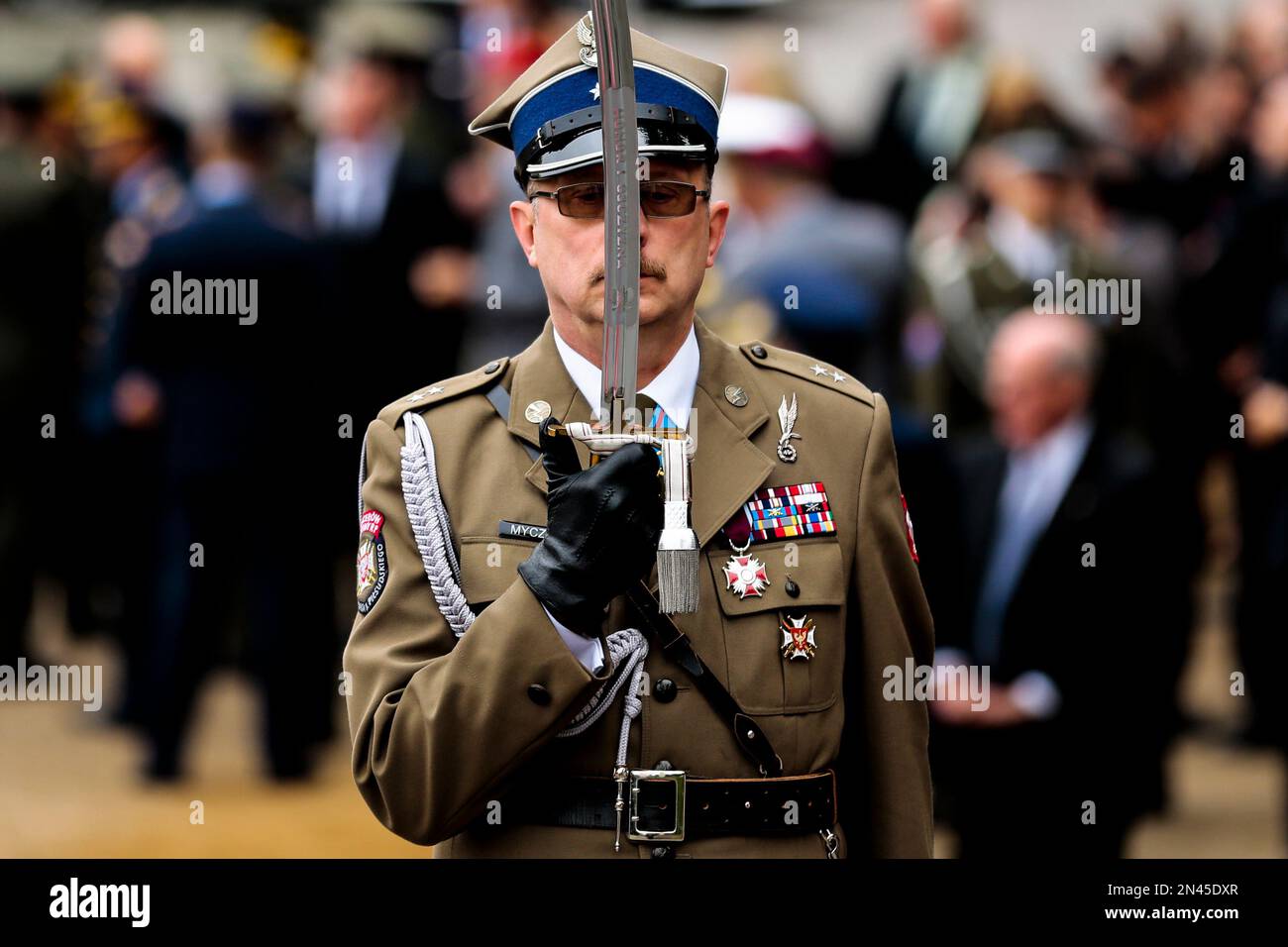 A Polish honor guard salutes as he attends a wreath laying ceremony to ...