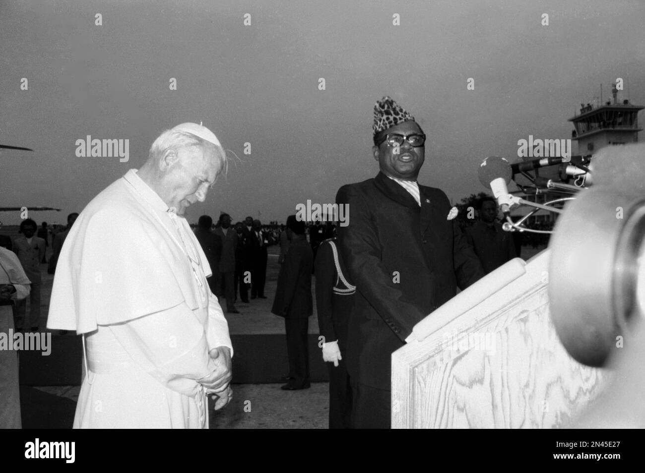 Pope John Paul II stands and listens while President Joseph Mobutu ...