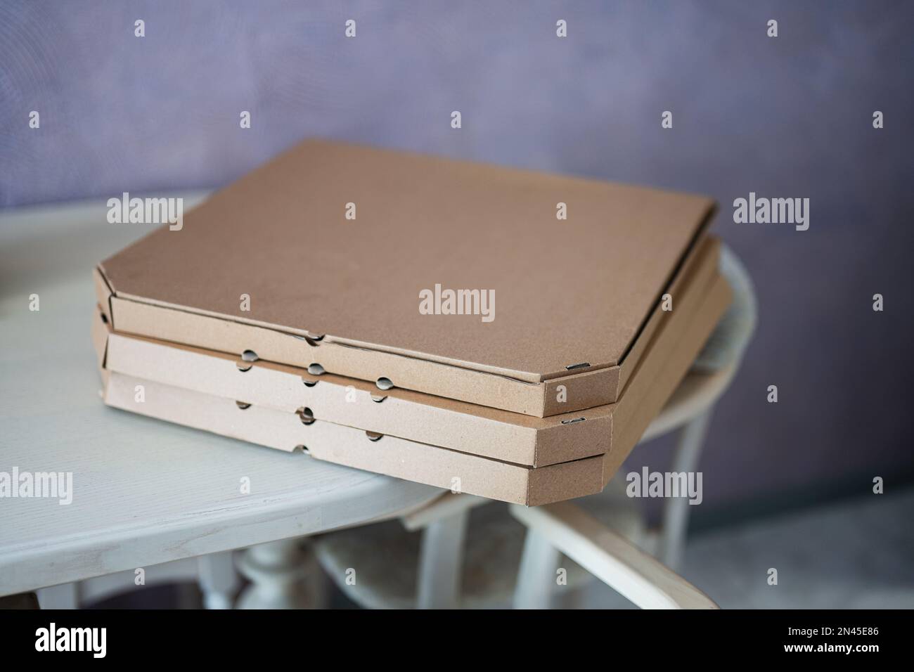 Cardboard pizza boxes on kitchen in table Stock Photo - Alamy