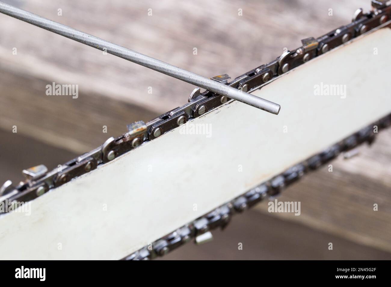 chainsaw chain sharpening with a special file. Dulling an old chain on ...
