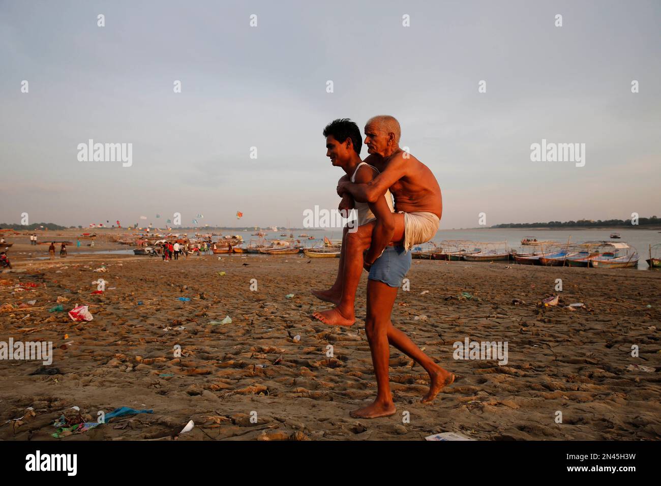 Indian youth Ajay Misra carries his 95 years old father Ramgiri Misra ...