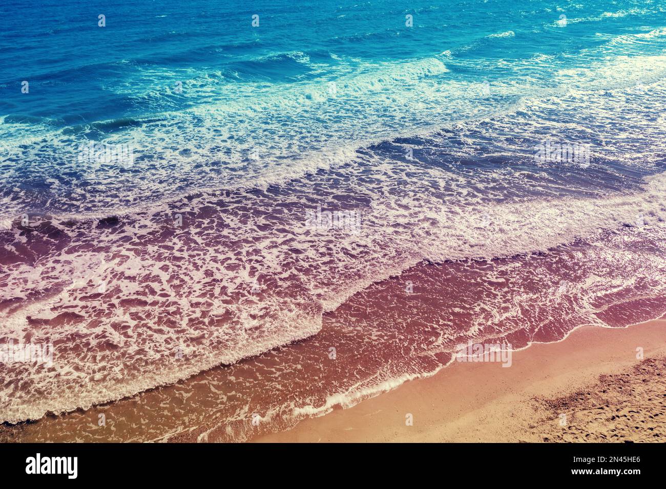 Sea surf on a sandy beach Stock Photo - Alamy