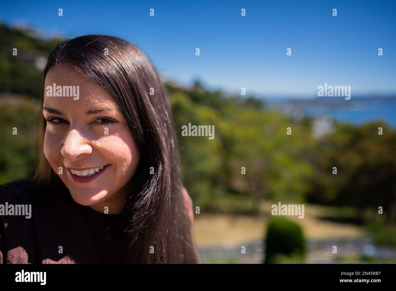 Beautiful girl brushing hair, model styling black hair getting ready to ...