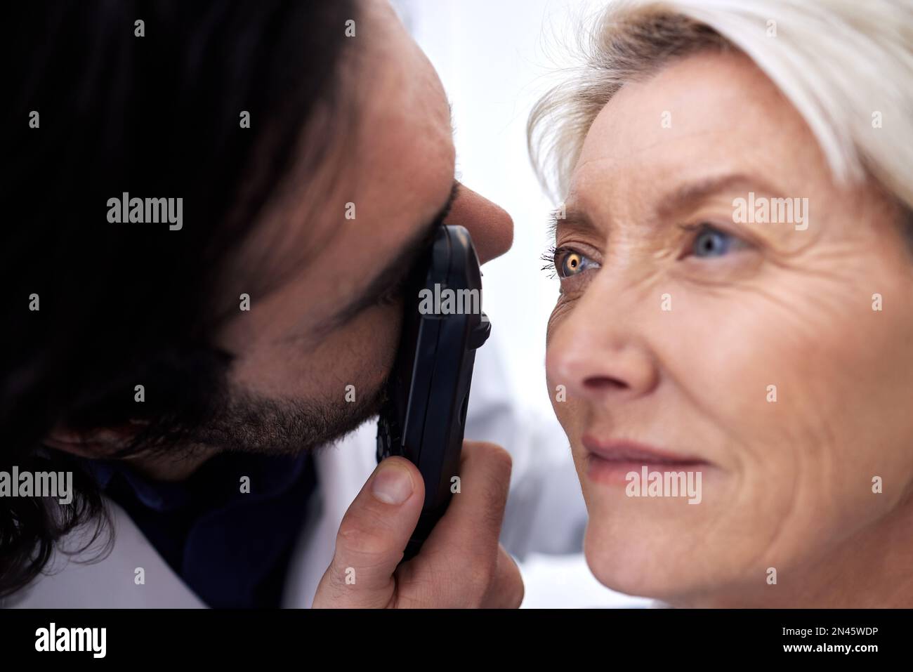 Light, eye check and woman with an optician for healthcare ...