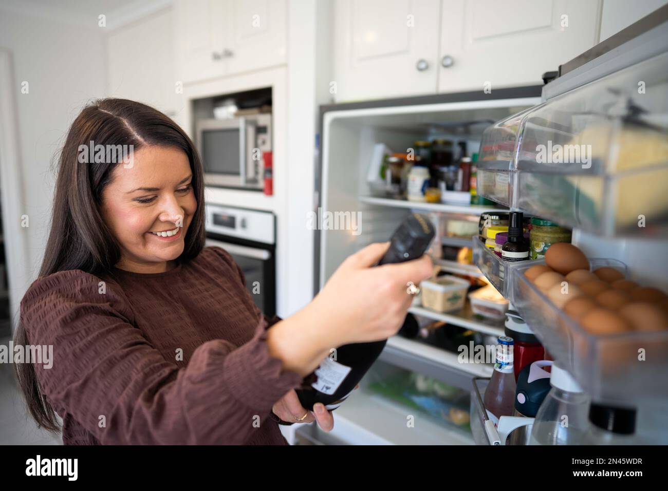 Getting food out of the fridge. Beer in the fridge. Fridge full of food ...