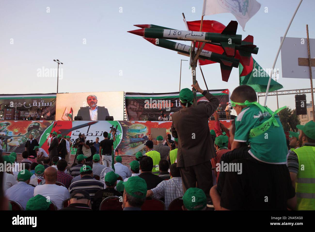 A celebrator carries a rocket decoy,as Khaled Mashaal, leader of the ...