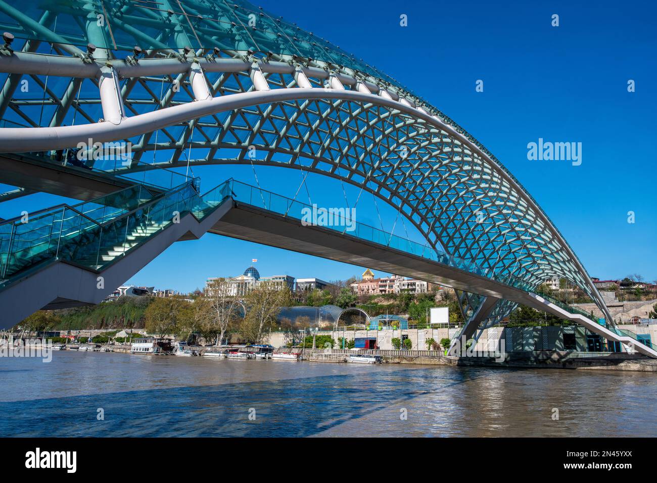 Pedestrian Peace bridge across the Kura River in Tbilisi. In the ...
