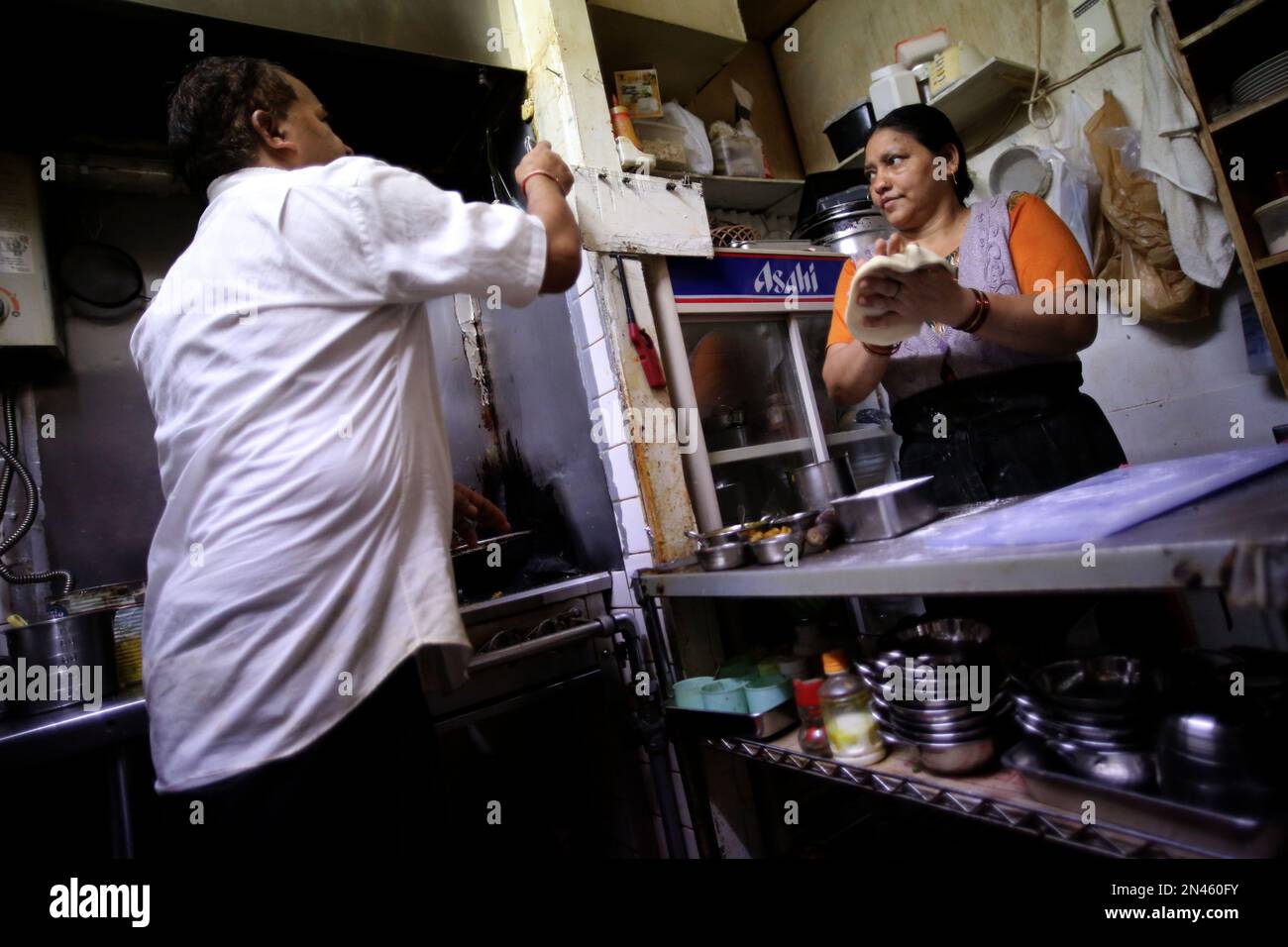 Indian employees prepare Indian food at their "Hari" Indian restaurant ...
