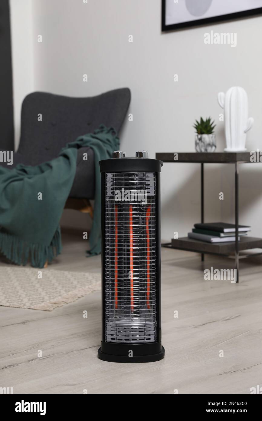 Modern electric halogen heater on floor in room interior Stock Photo ...