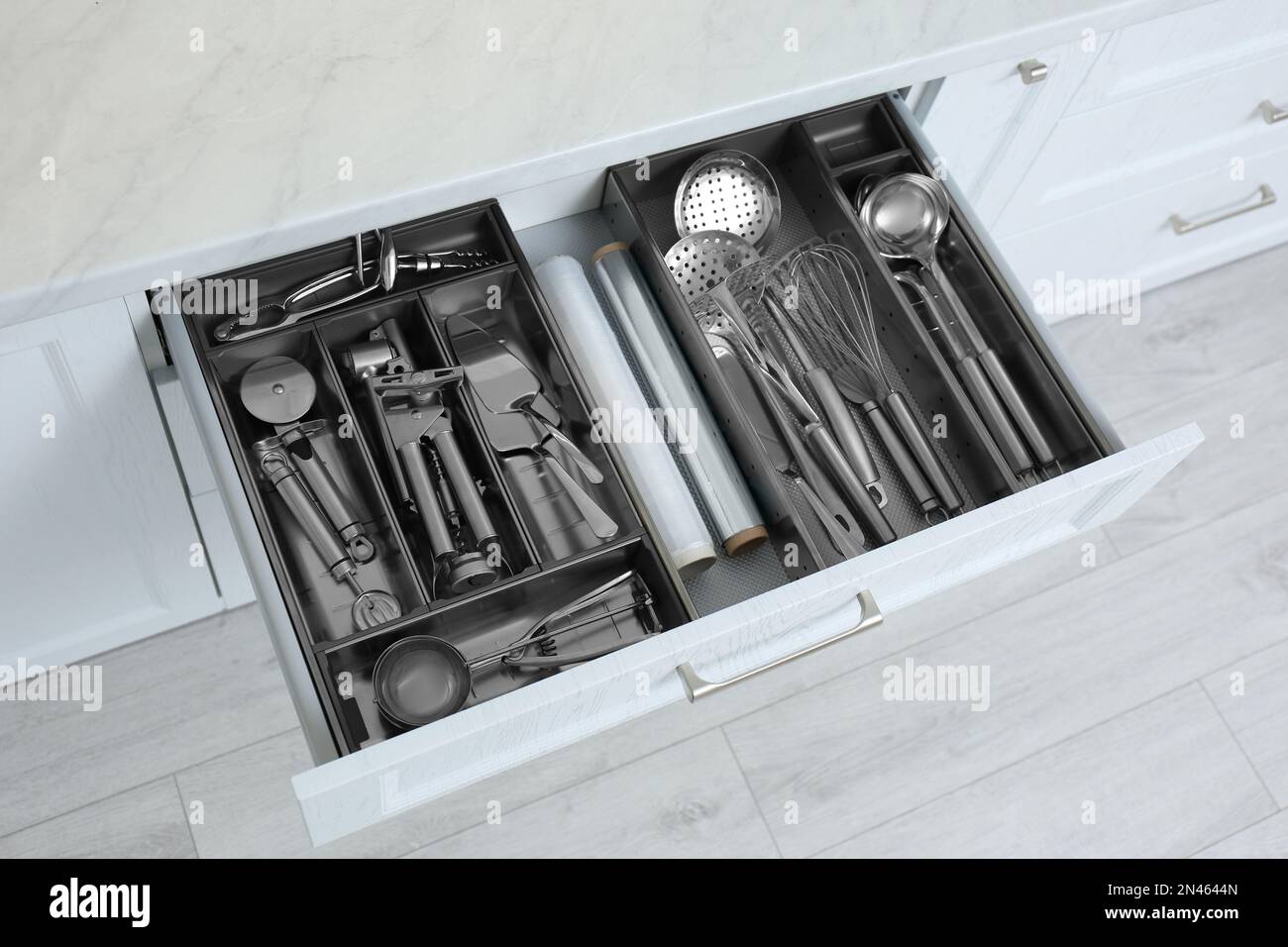 Open drawer with stainless steel utensil set. Order in kitchen Stock ...