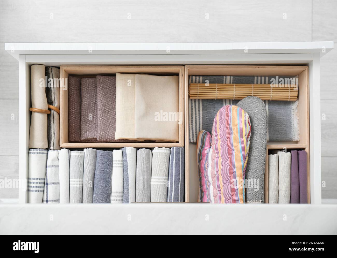 Open drawer with different textiles in kitchen, top view Stock Photo ...