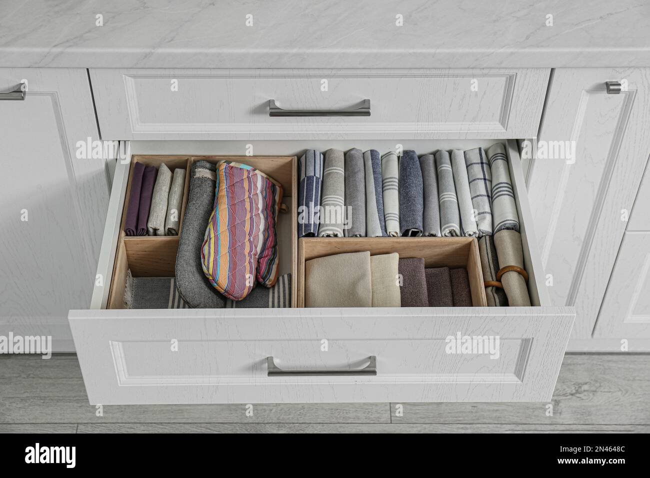 Open drawer with different textiles in kitchen Stock Photo - Alamy