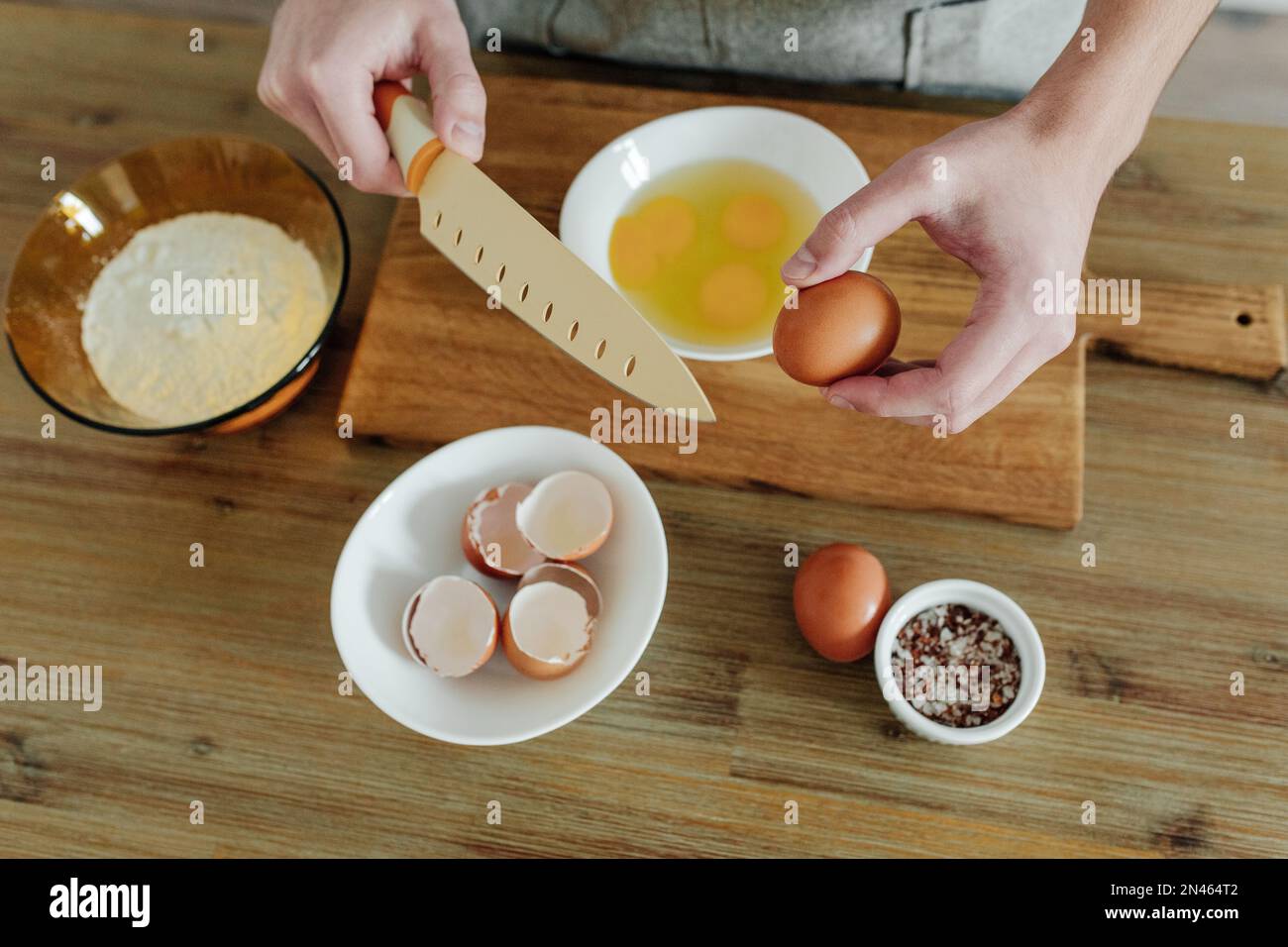 Cooking in progress. Eggs, flour, salt on the table, cutting board and ...