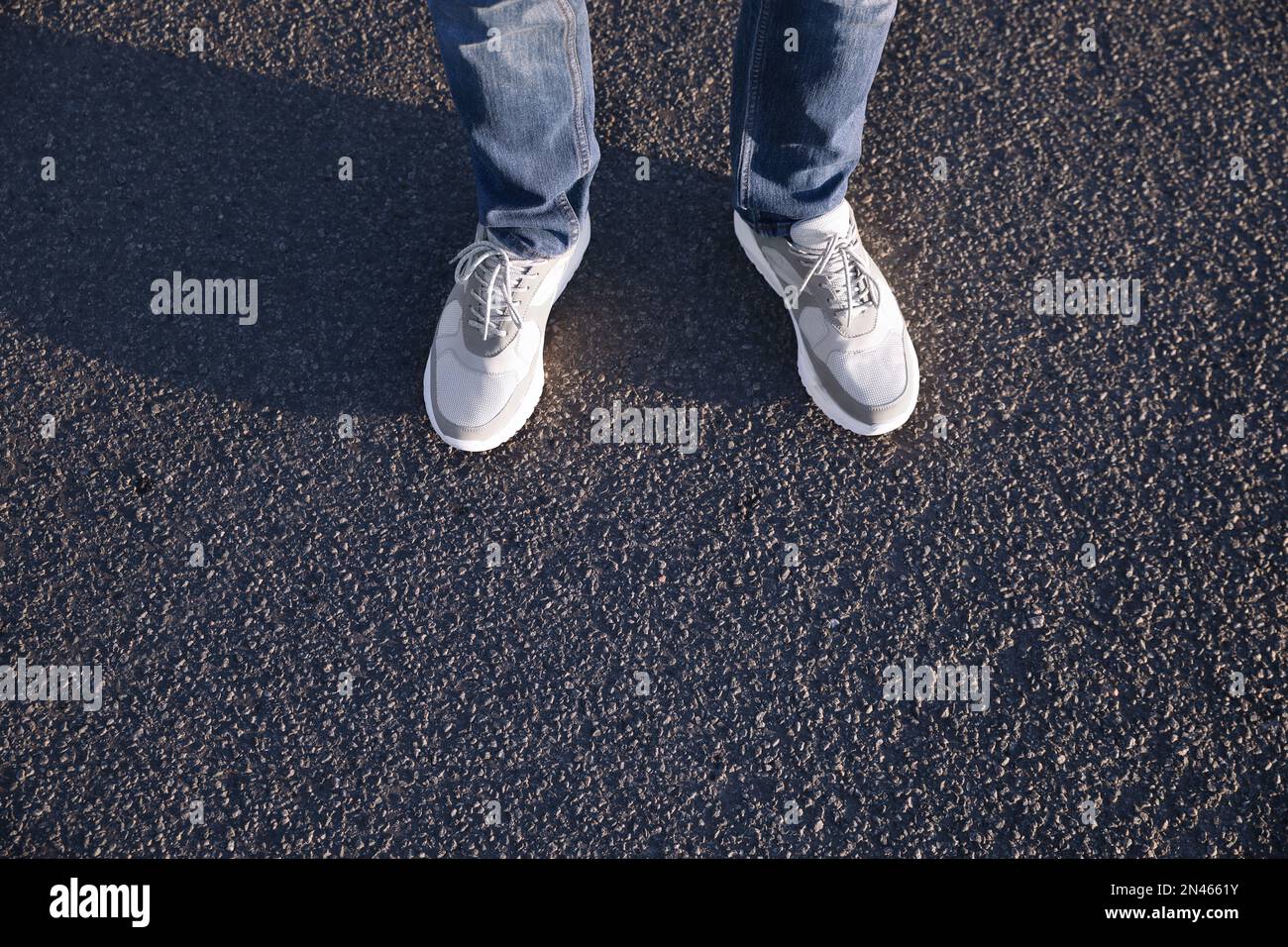 Man standing on road, closeup with space for text. Choosing way concept ...