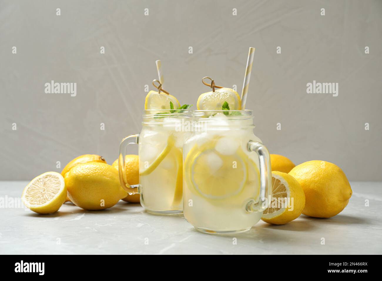 Natural lemonade with mint and fresh fruits on light grey marble table ...