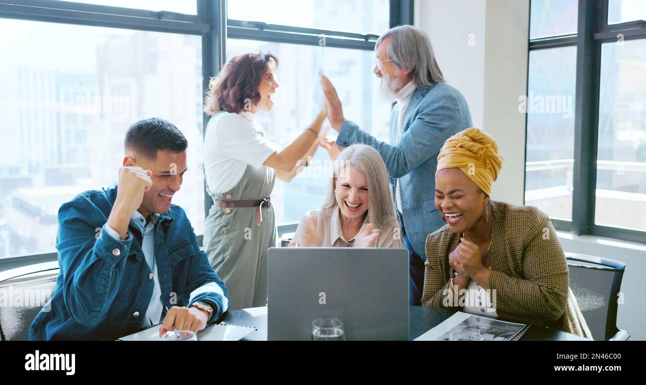 Teamwork, high five and applause of business people on laptop celebrating success, goals or ...