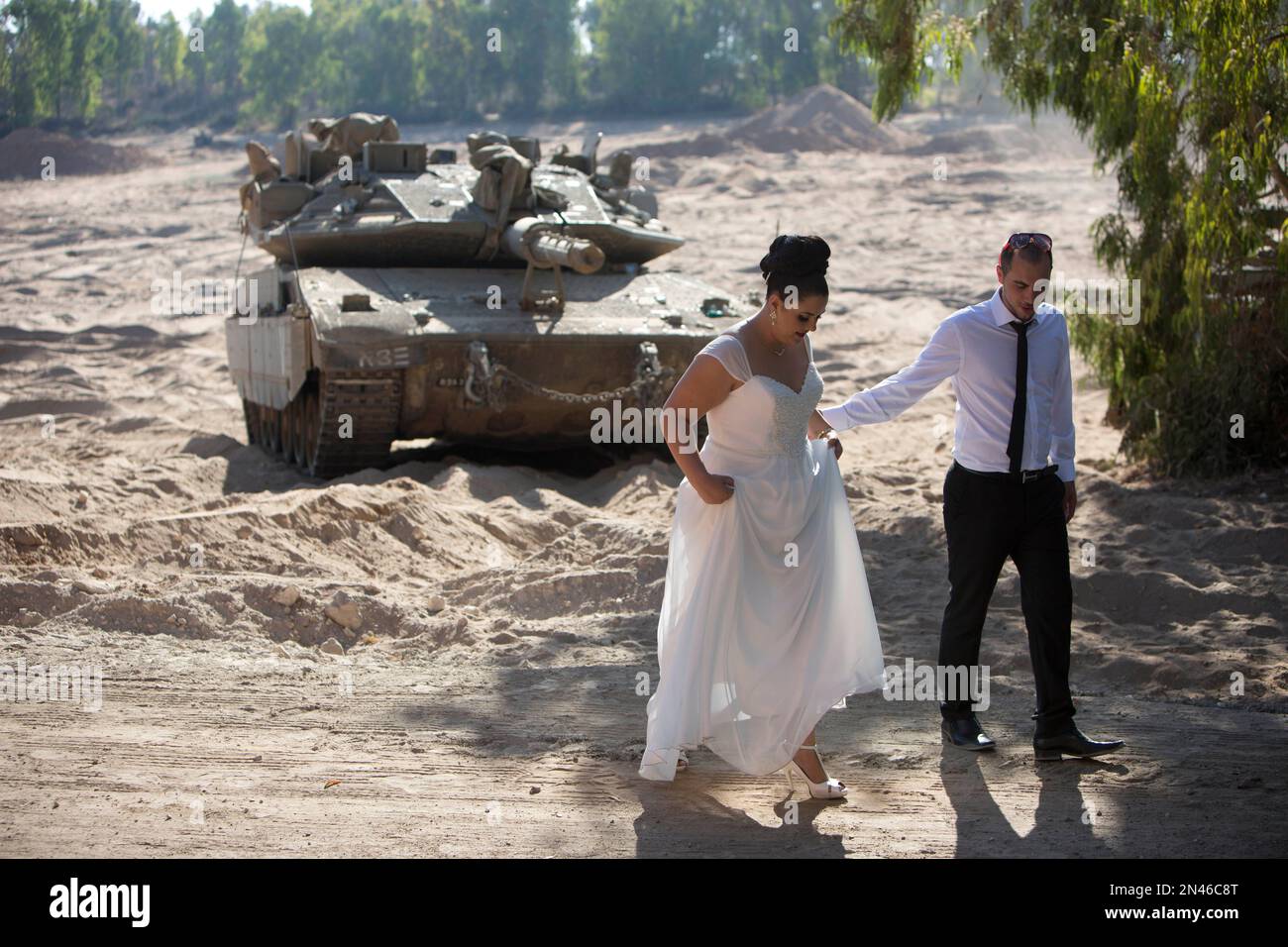 Israeli couple, Noga and Moshiko Siho, leave an army staging area after ...