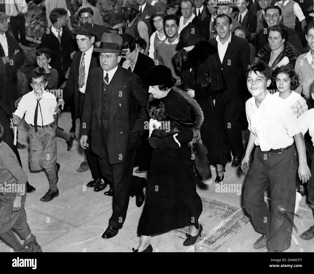 A crowd follows Mrs. Laura Kilpatrick Morgan, center foreground, mother ...