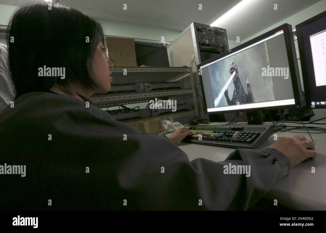 A film process technician checks the digitalized film of a Godzilla ...