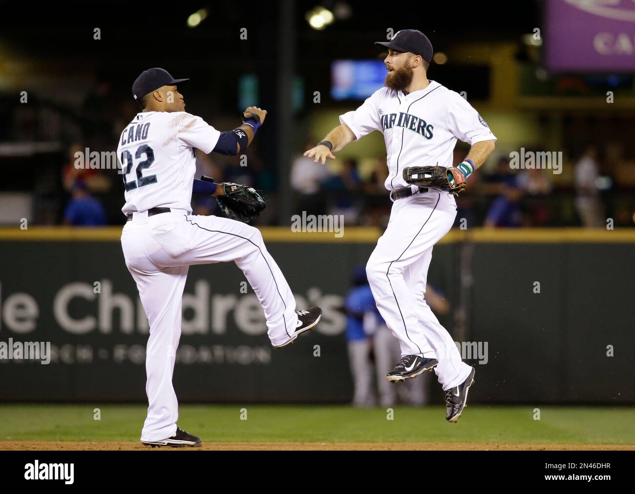 Seattle Mariners' Robinson Cano (22) and Dustin Ackley share ...