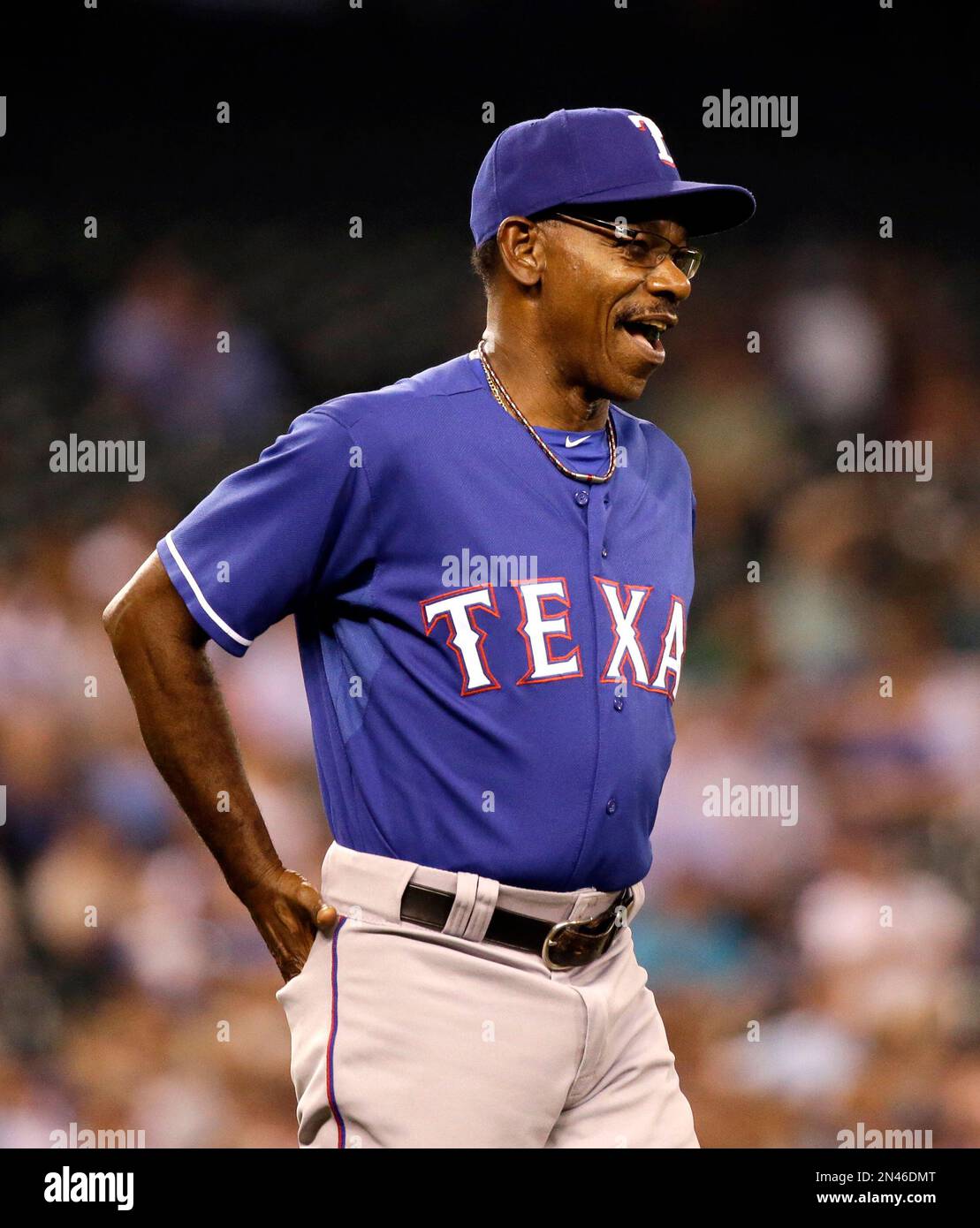 Texas Rangers manager Ron Washington heads onto the field to speak with ...