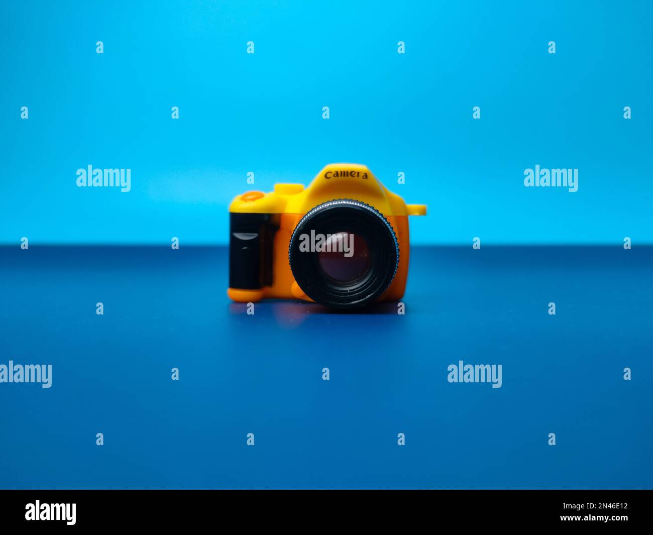 The yellow camera in the middle with a blue background Stock Photo - Alamy
