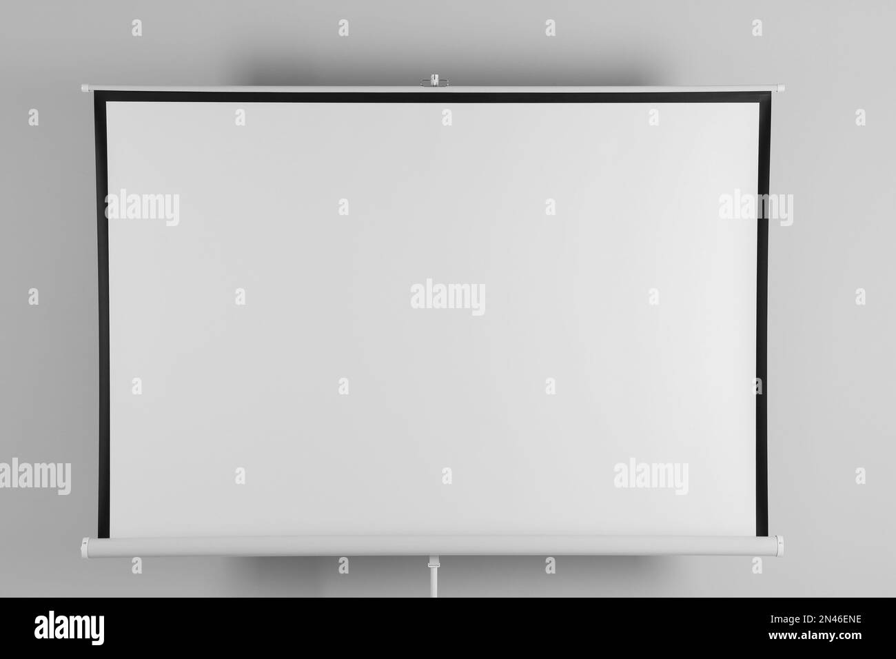 Blank projection screen near white wall indoors. Space for design Stock ...