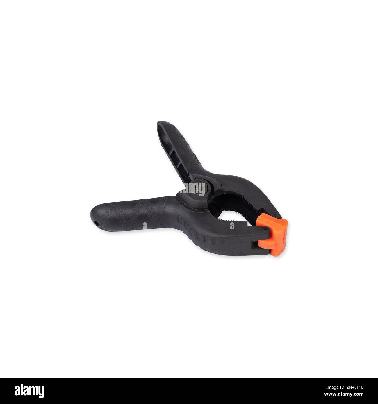 Plastic black and orange spring clamp isolated over white background ...