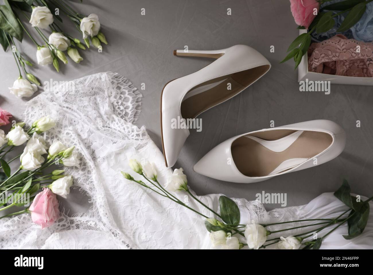 Flat lay composition with wedding dress, white high heel shoes and ...