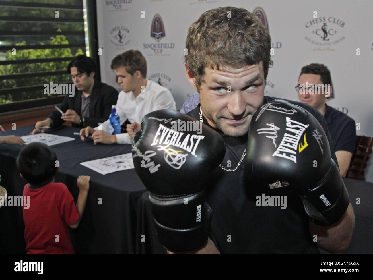 Chess boxer Justin Grimes shows off his signed boxing gloves at the ...