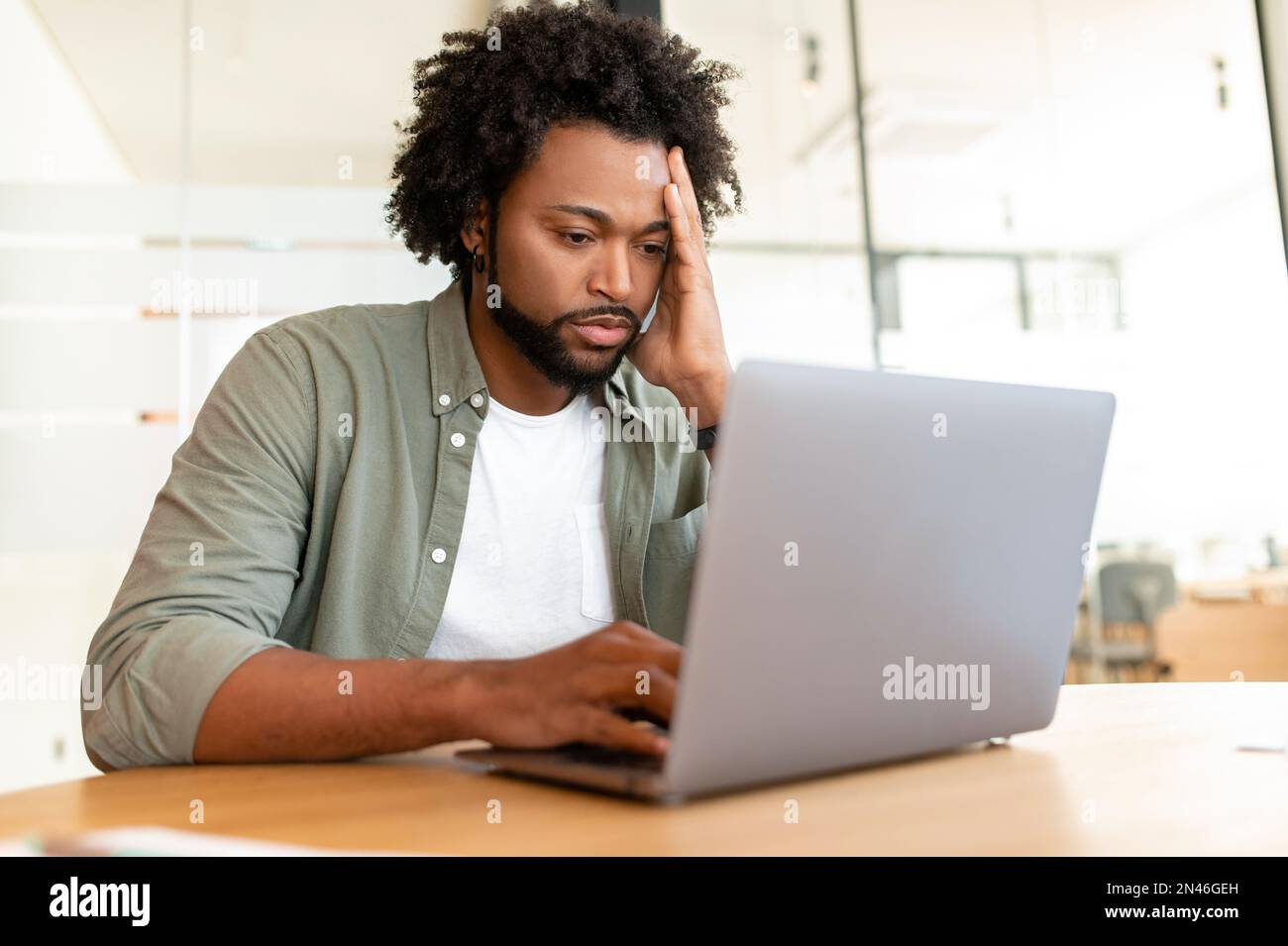 Fatigued businessman using laptop for working, the guy tired and ...
