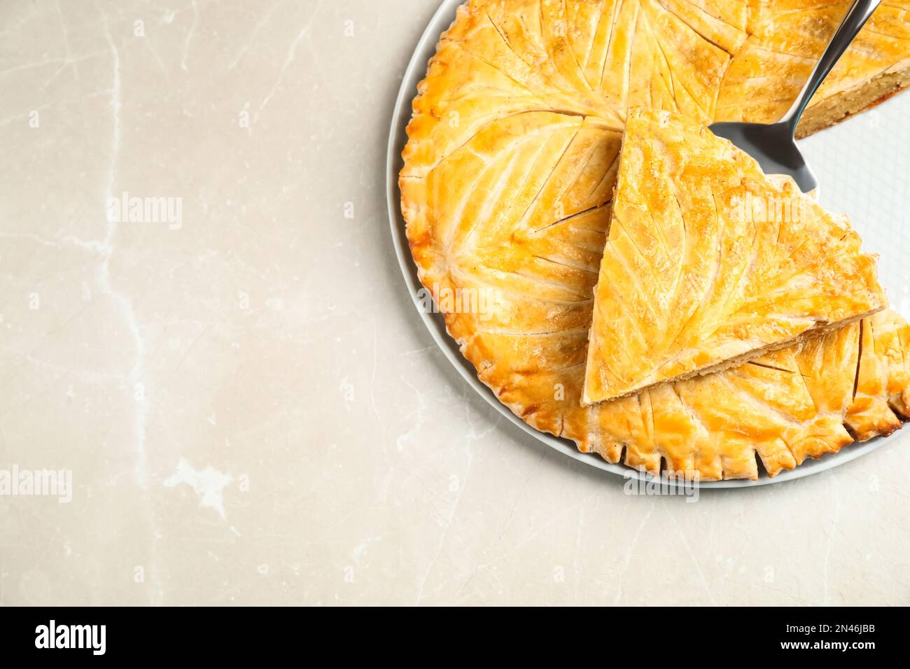 Traditional galette des rois on light grey marble table, top view ...