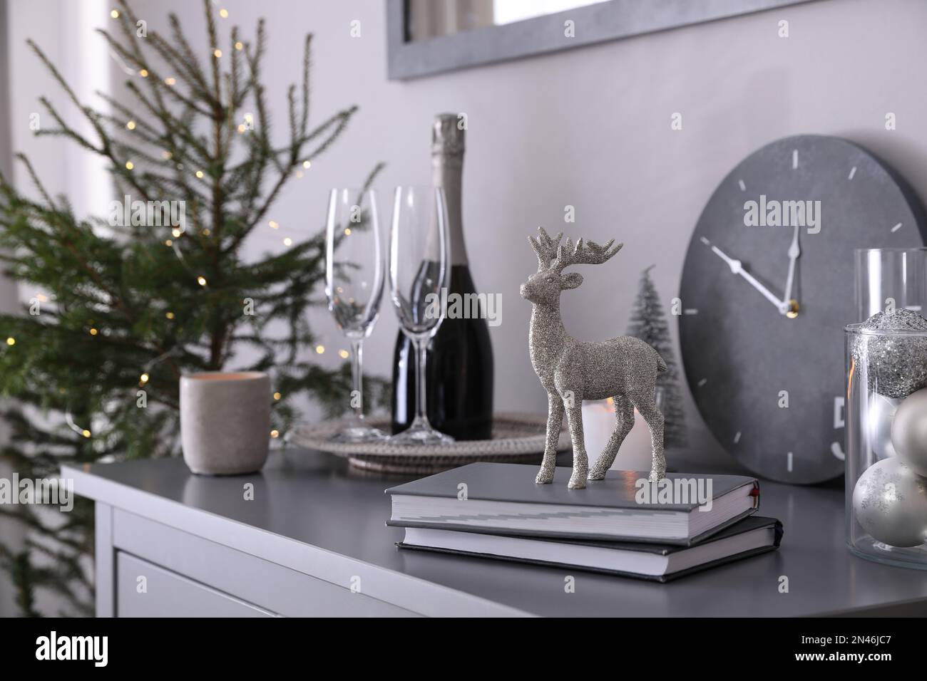 Christmas tree and decor on chest of drawers indoors. Interior design ...