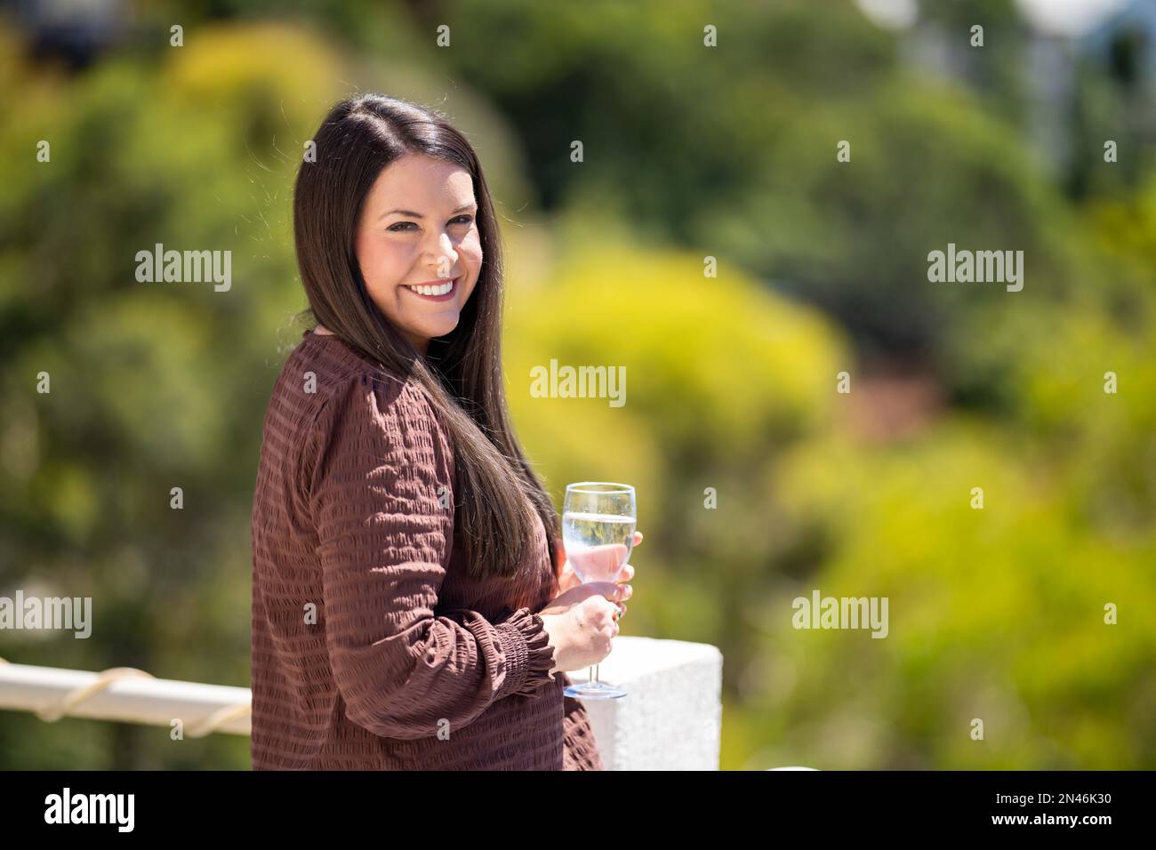 beautiful lady on a balcony having a drink in hobart australia im ...