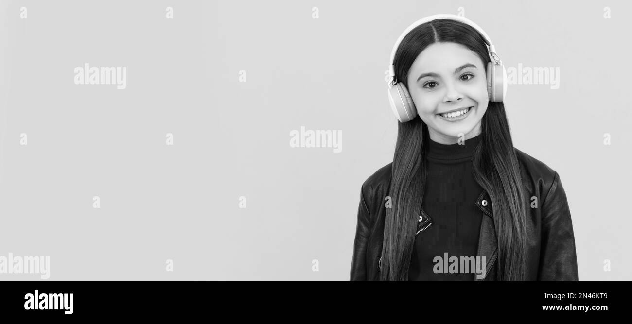 happy teen girl listen music in headphones on yellow background with ...