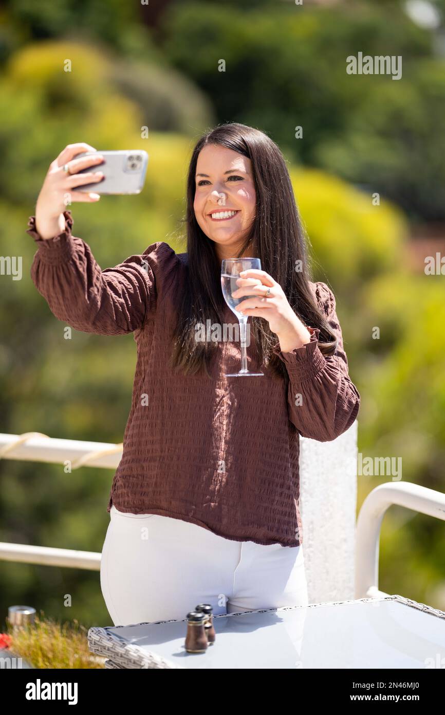 Girl video calling her friends on a zoom call. Woman on holiday skyping ...