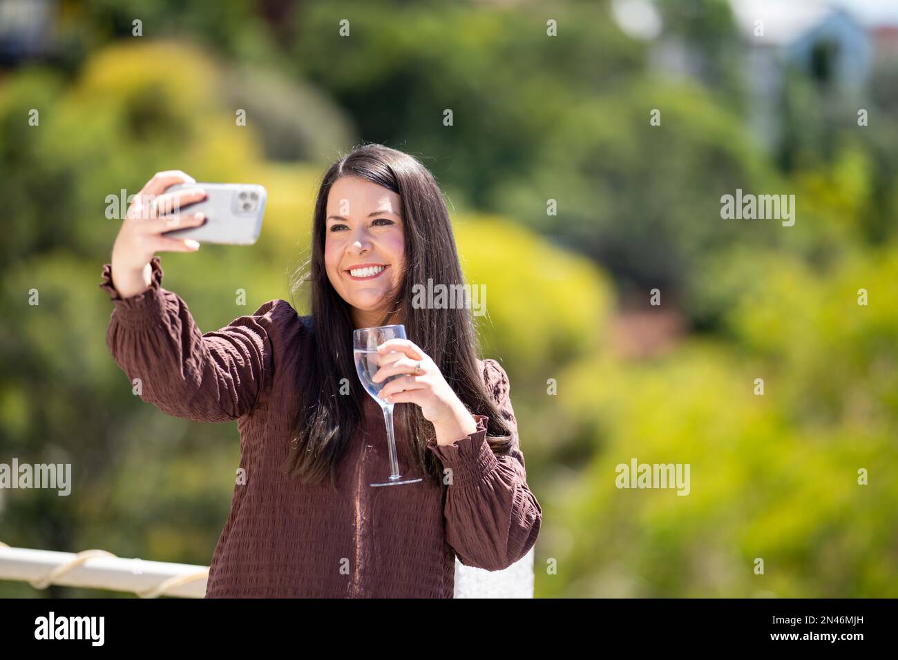 Girl video calling her friends on a zoom call. Woman on holiday skyping ...