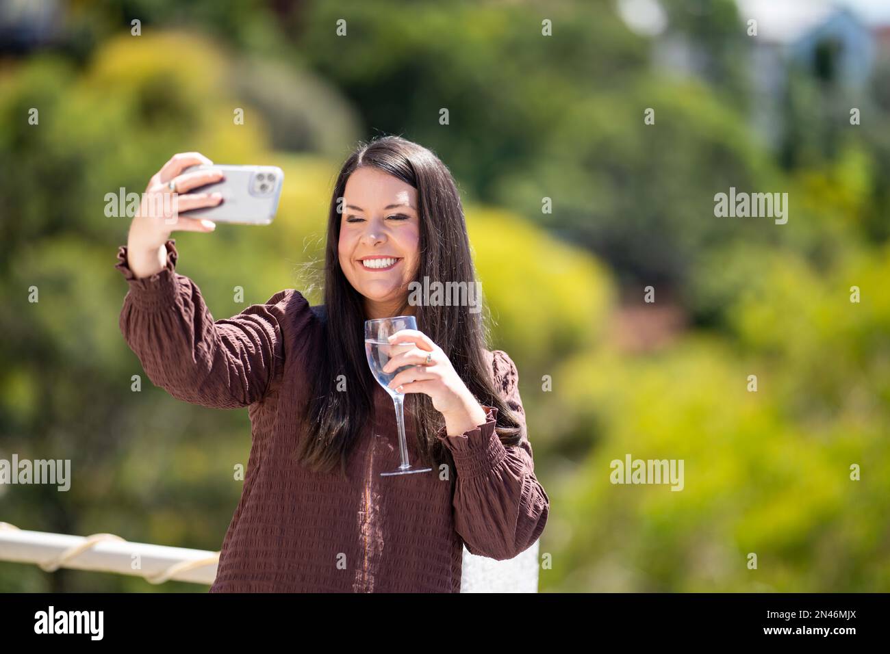 Girl video calling her friends on a zoom call. Woman on holiday skyping ...