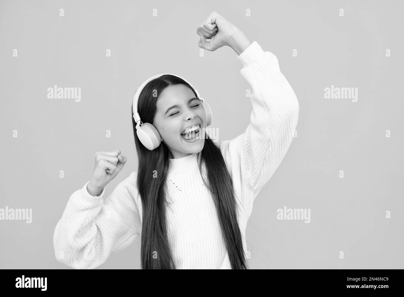Excited face. Teen girl in headphones listen to music. Wireless headset ...