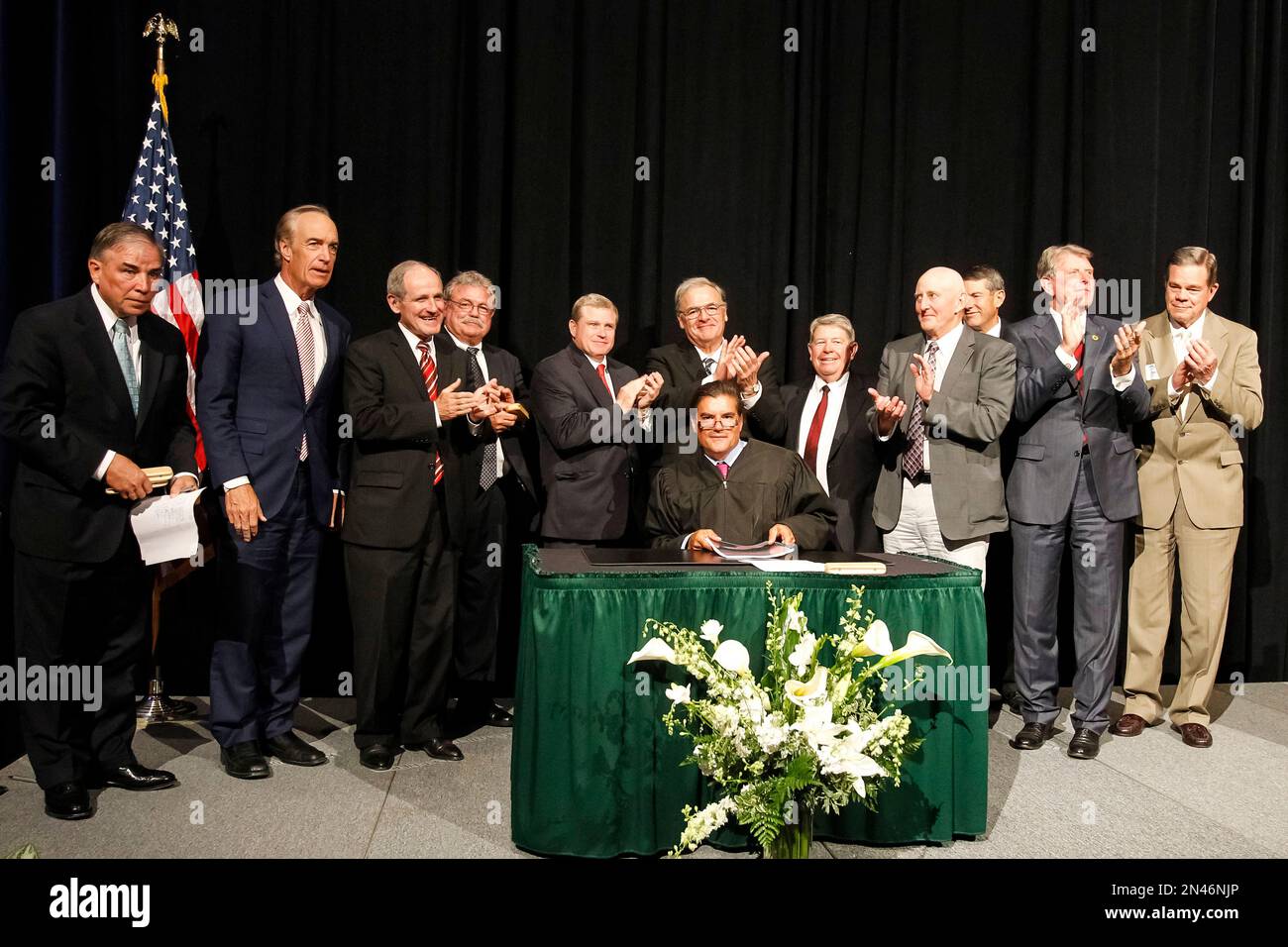 Snake River Basin Adjudication Judge Eric Wildman, seated, signs the ...