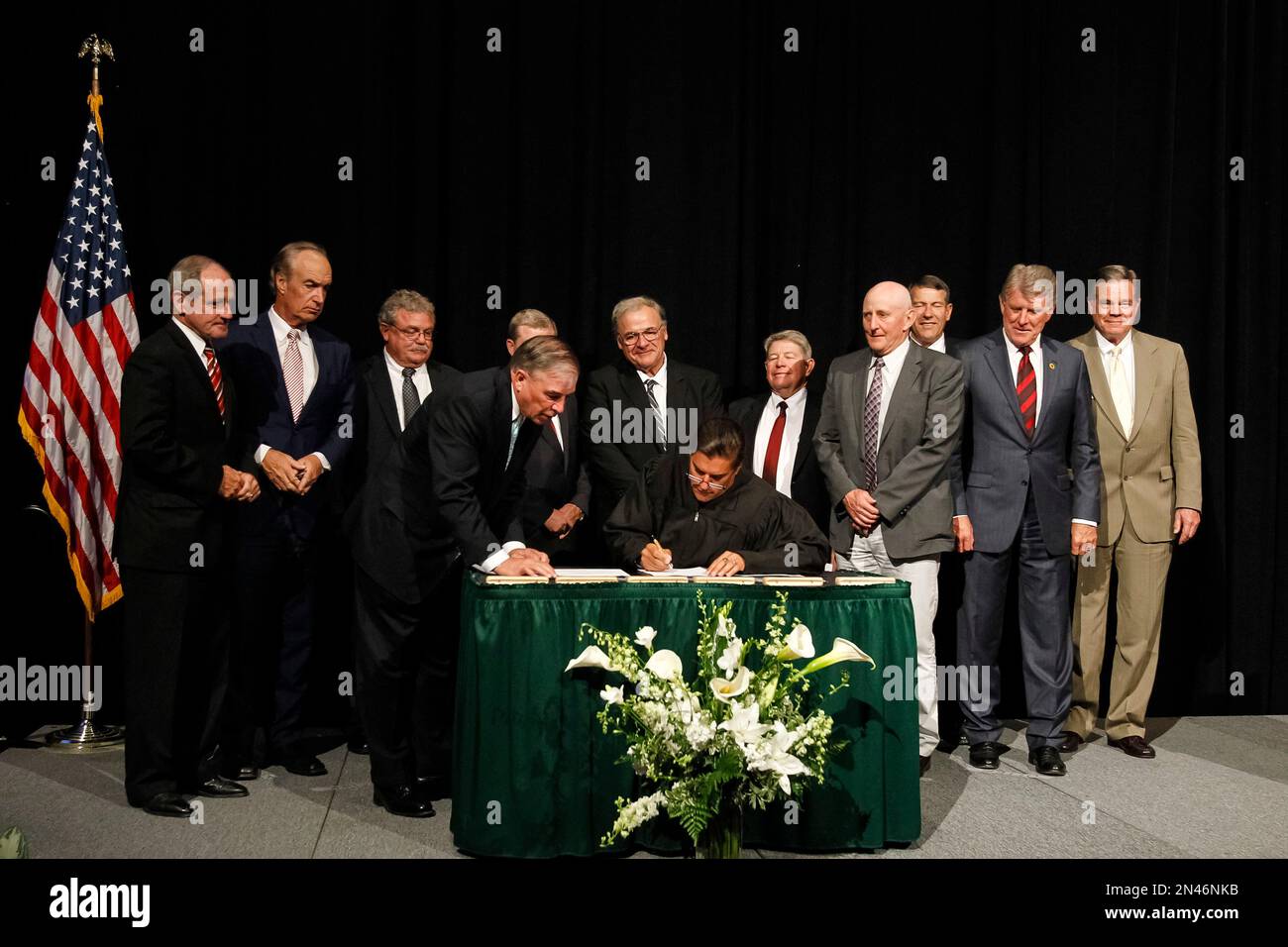 Snake River Basin Adjudication Judge Eric Wildman, seated, signs the ...