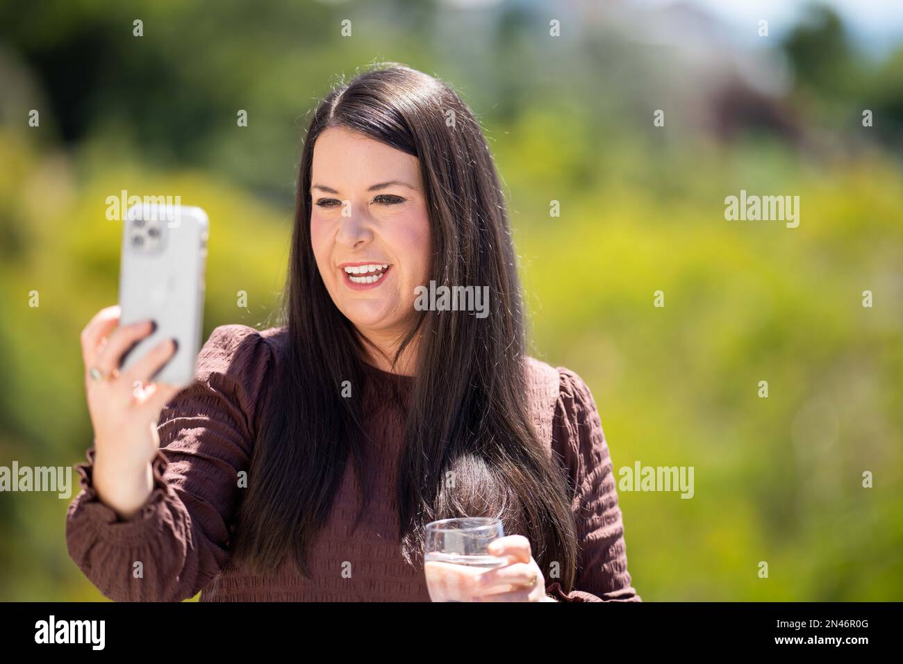 Girl video calling her friends on a zoom call. Woman on holiday skyping ...