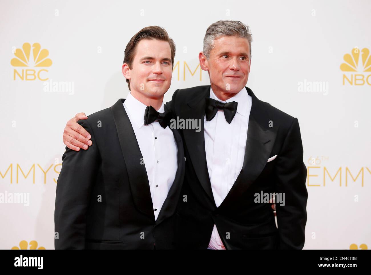 Matt Bomer, left, and Simon Halls arrive at the 66th Primetime Emmy ...