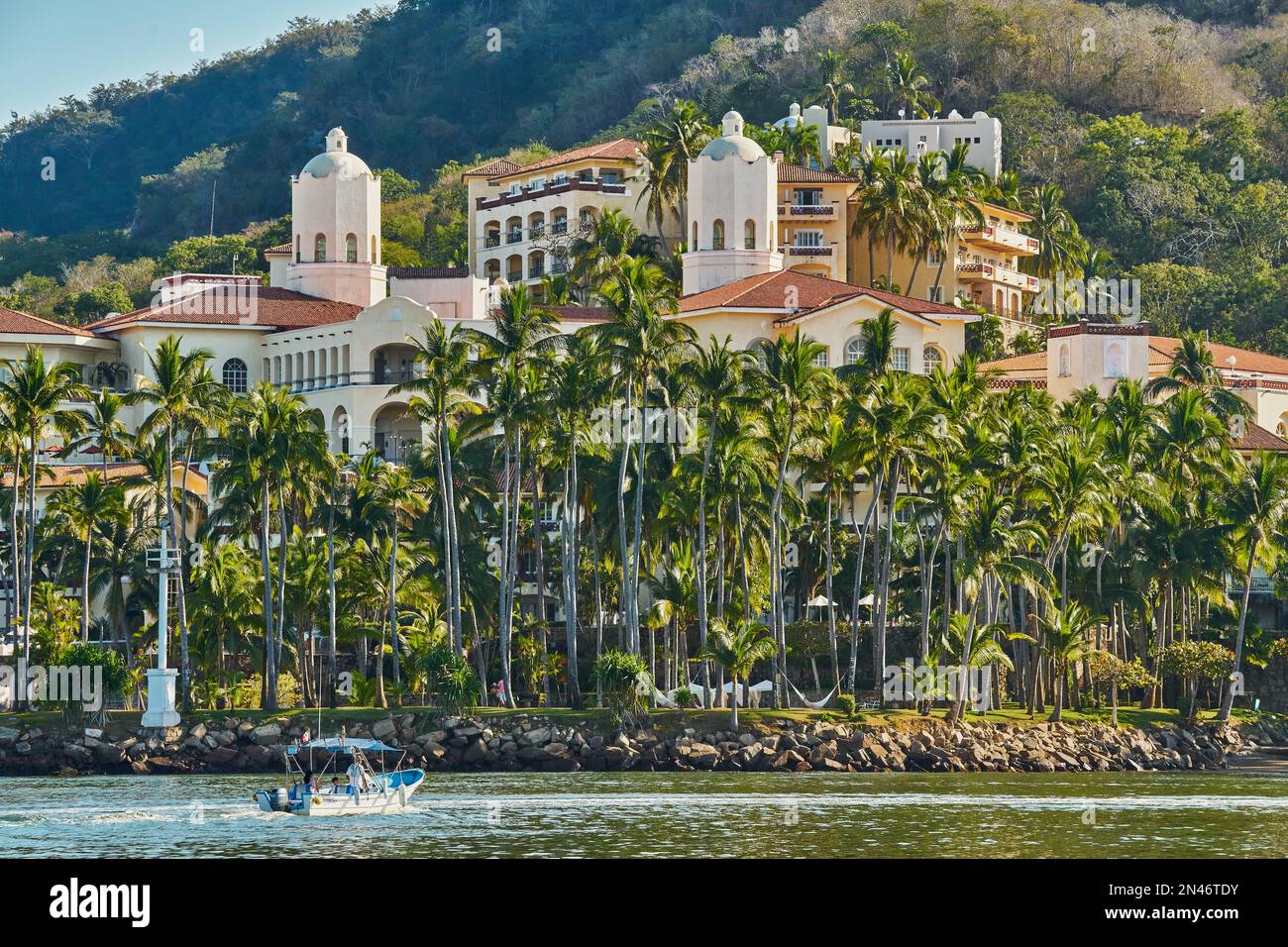 very large luxury hotel located in the middle of palm trees and right ...