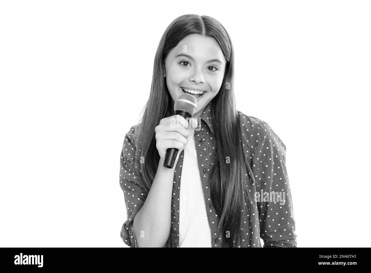 Cute girl holding a microphone and singing a song. Singer girl sings in ...