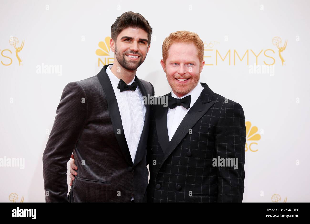 Justin Mikita, left, and Jesse Tyler Ferguson arrive at the 66th ...